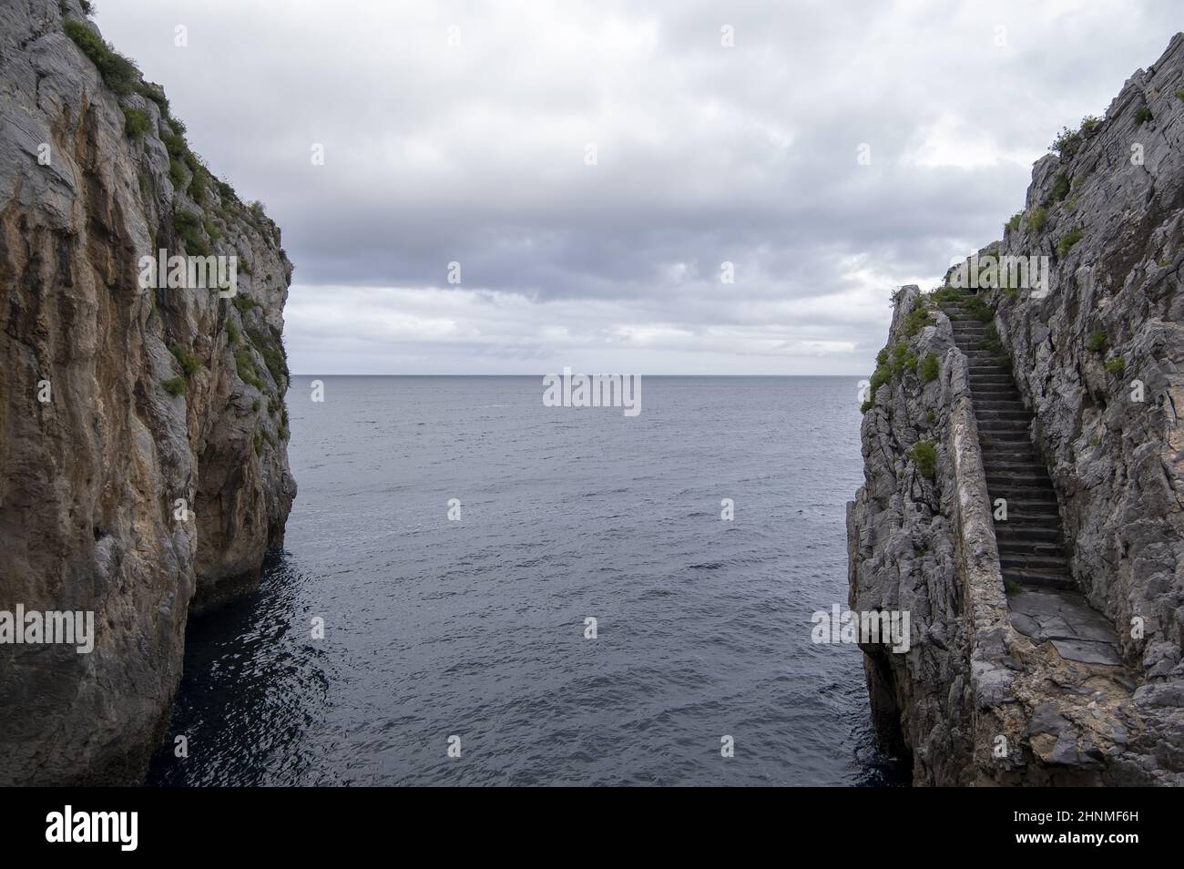 Detail of cliffs with stairs on a beach in Spain, tourism Stock Photo ...
