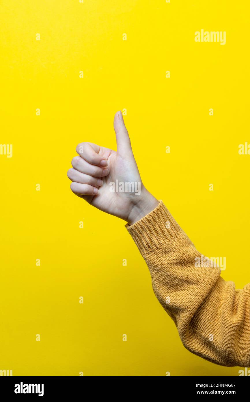 a woman's thumb finger pointing up in approval Stock Photo - Alamy