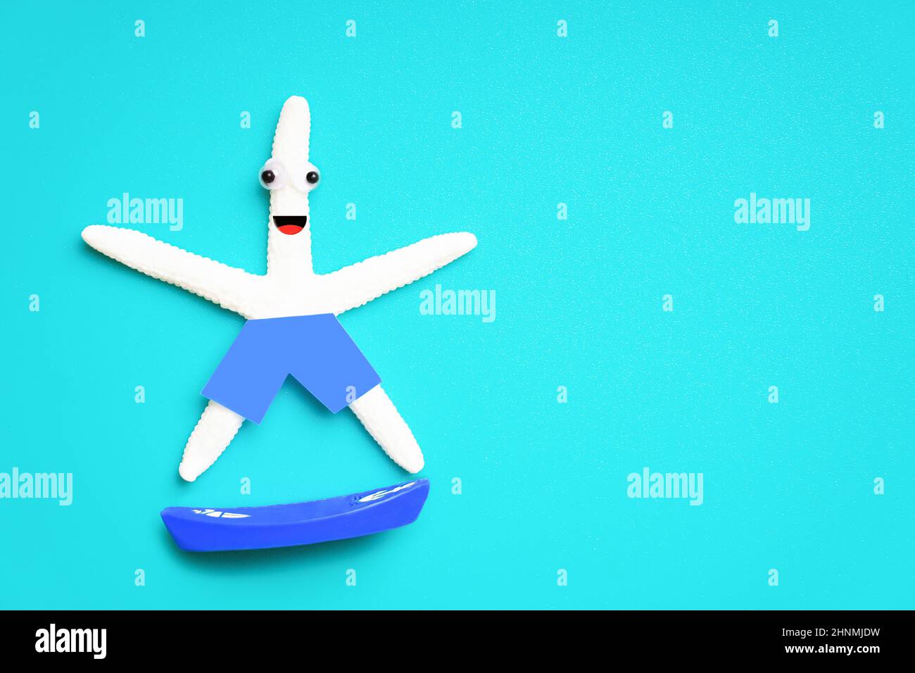 Cute starfish character riding a toy surfboard isolated on a light blue ...