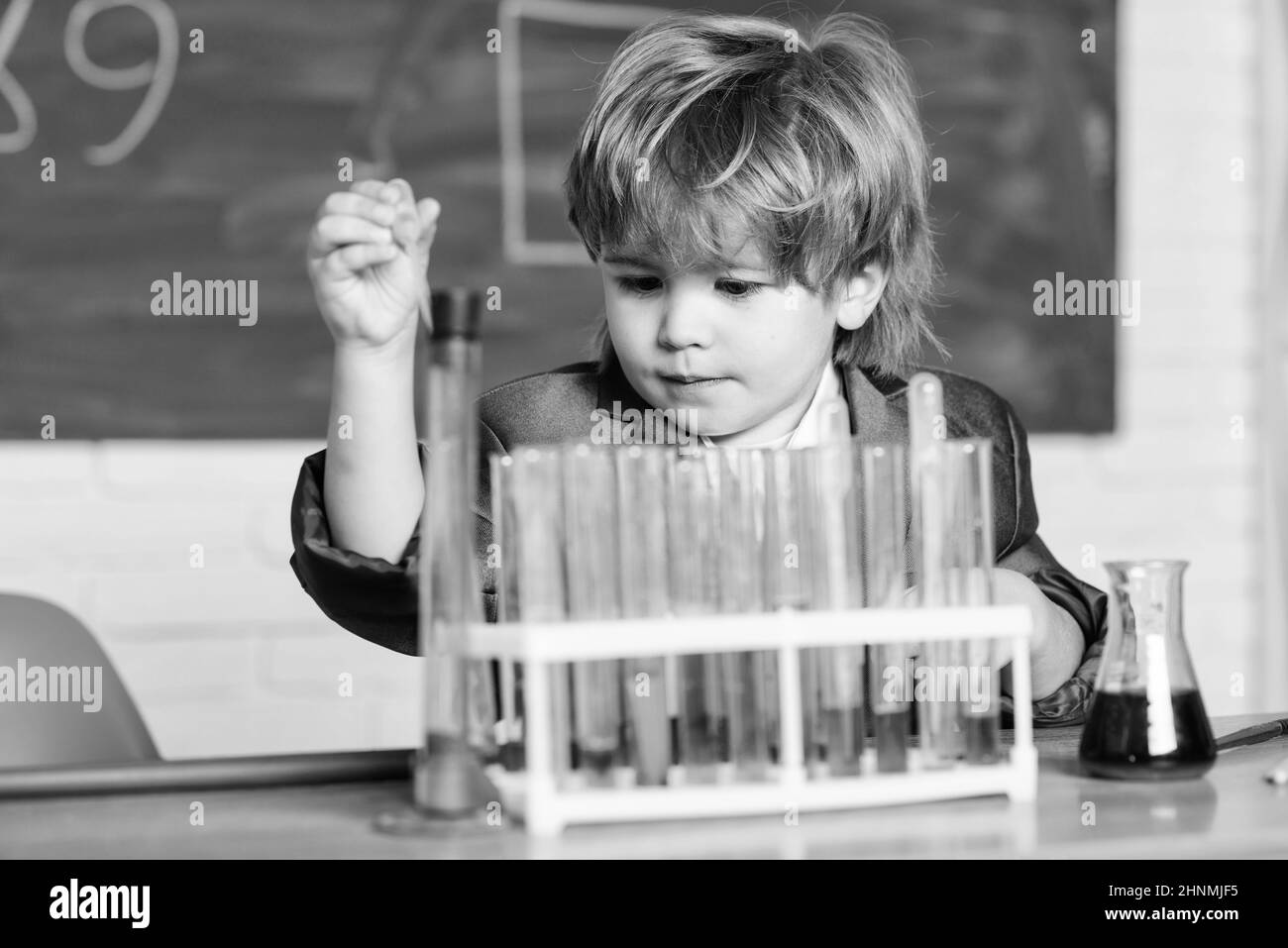 Little boy is making science experiments. school kid scientist studying ...
