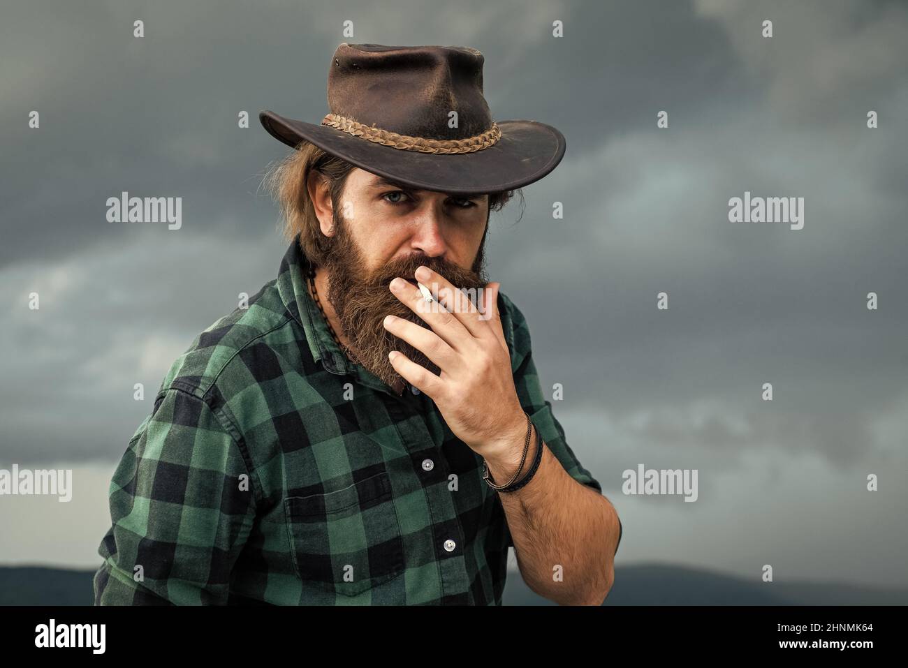 Young cowboy smoking cigarette hi-res stock photography and images - Alamy