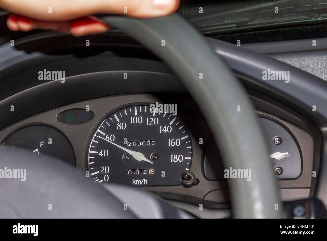 Hand on the handlebars in the car. Speedometer and steering wheel Stock ...