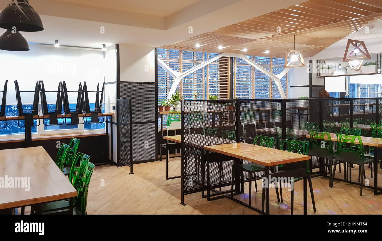 Cafeteria, no people dining room with wooden tables and green chairs ...