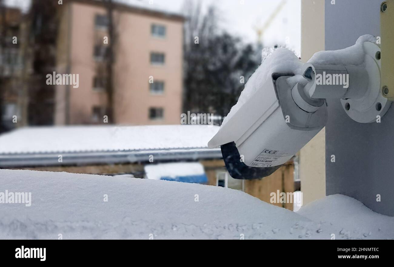 Large white surveillance camera over a window against the backdrop of a ...