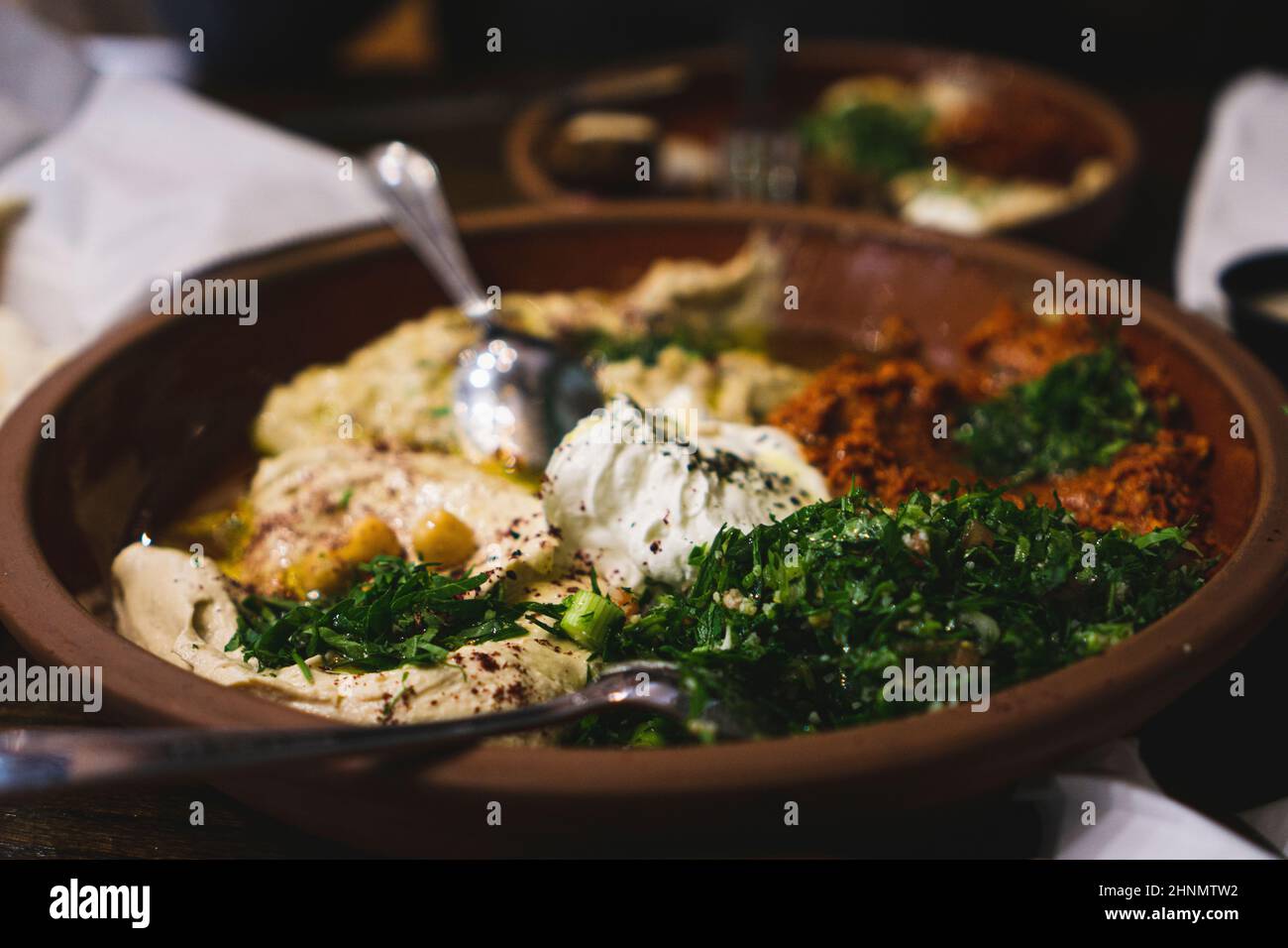 Assorted Middle Eastern dishes including hummus, baba ghanoush ...