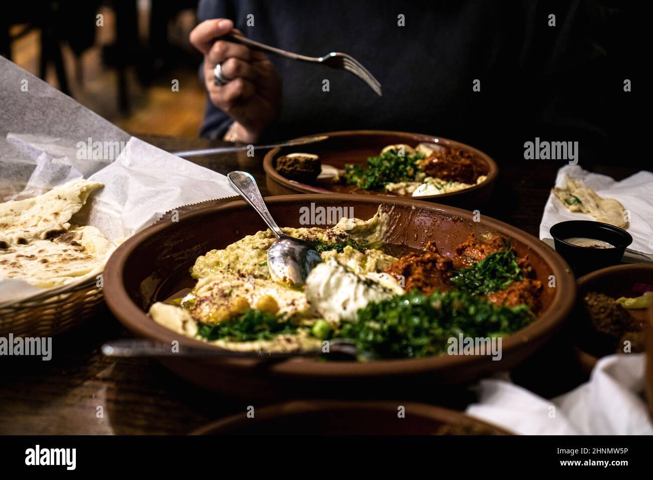 Assorted Middle Eastern dishes including hummus, baba ghanoush ...