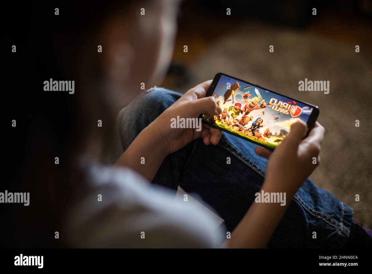 Illustrative editorial image of child playing Clash of Clans mobile ...