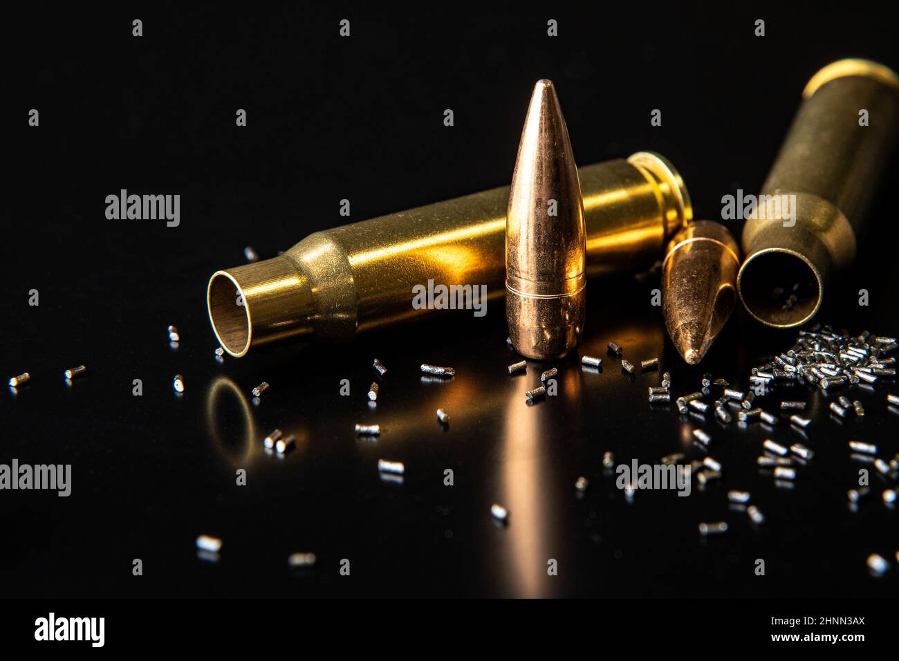 Close-up of disassembled rifle cartridges. Bullet isolated on black ...