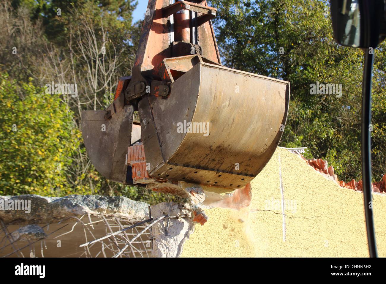 Loading construction rubble with an excavator in a dusty environment ...