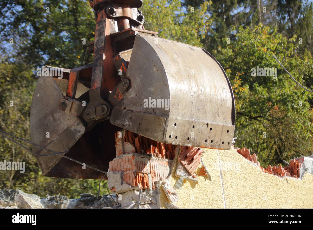 Loading construction rubble with an excavator in a dusty environment ...