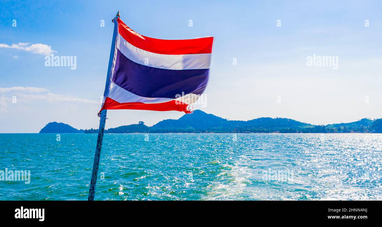 The national flag of Thailand in the rough wind and blue sky at island ...