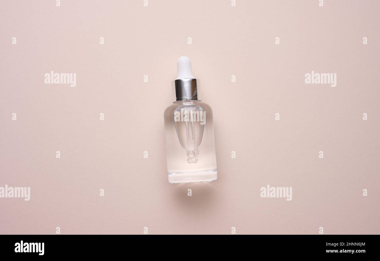 glass transparent white bottle with a pipette. Container for cosmetics ...
