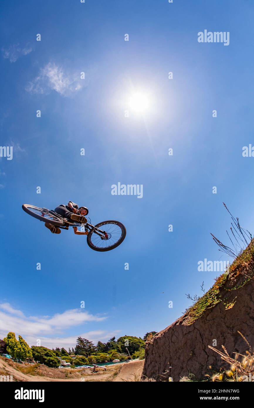 jumps with his dirt bike over the ramp at an artificial trial Stock ...