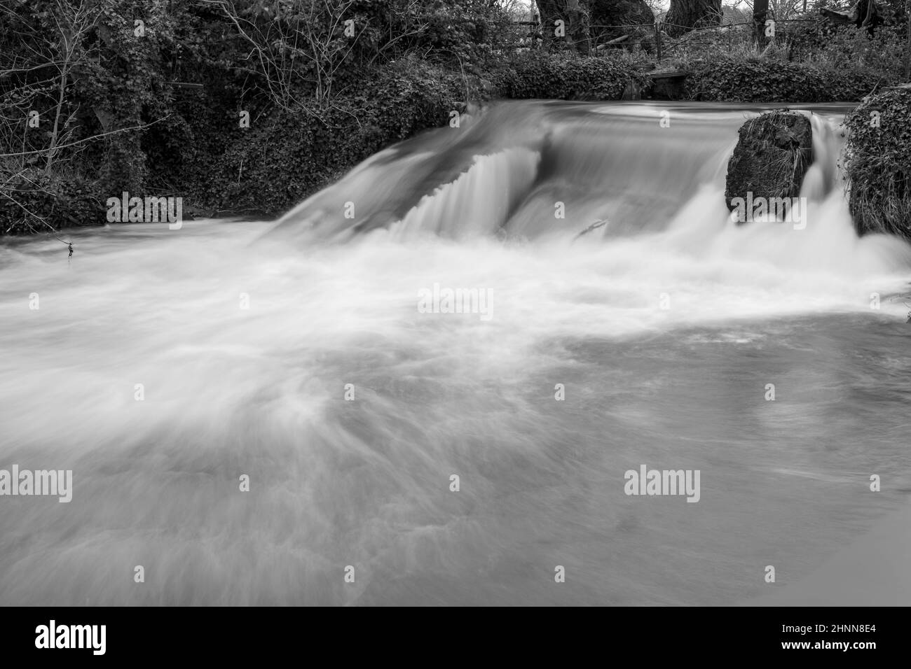 Long exposure of a waterfall on the river Avill in Dunster in Somerset ...