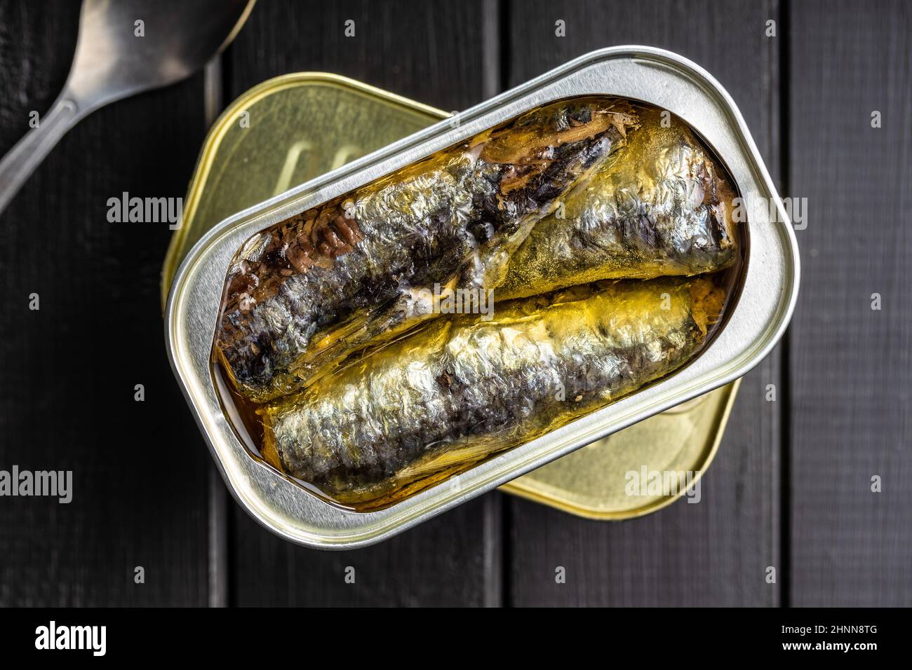 Canned sardines. Sea fish in tin can on black table. Top view Stock ...
