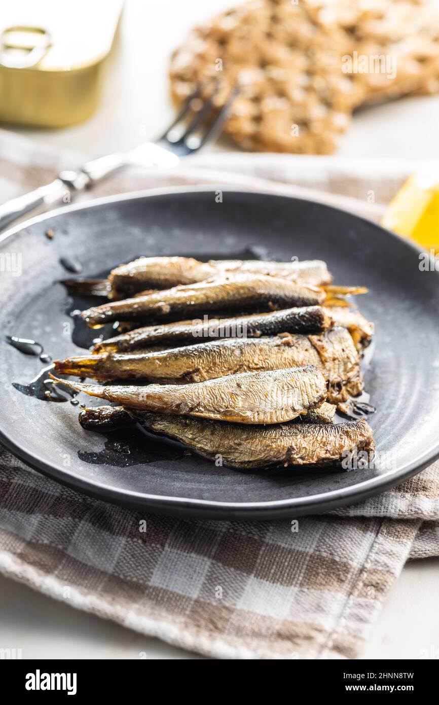 Smoked sprats on plate. Canned sea fish Stock Photo - Alamy