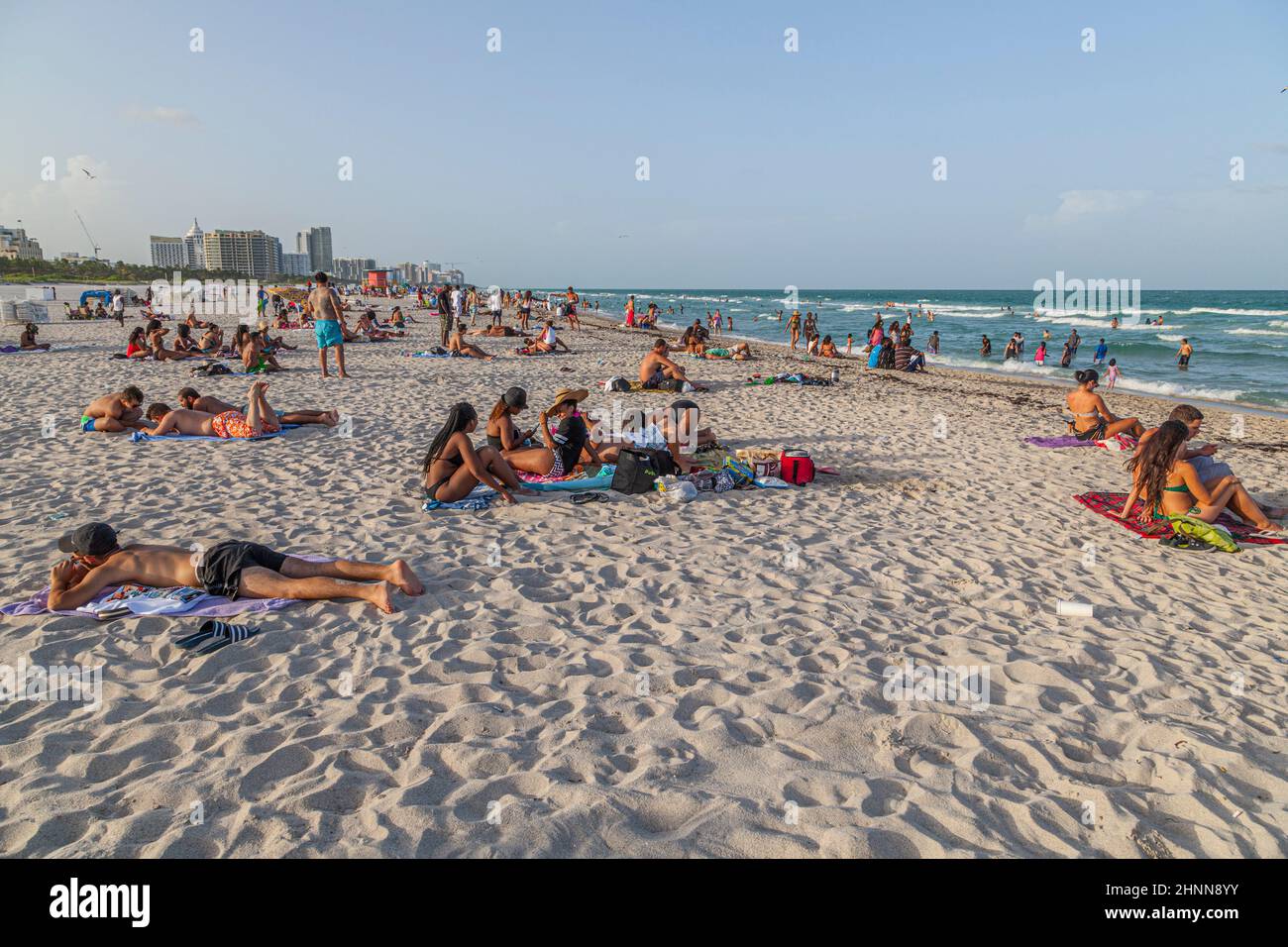 people enjoy the famous south beach sunset in Miami Beach and relax in ...