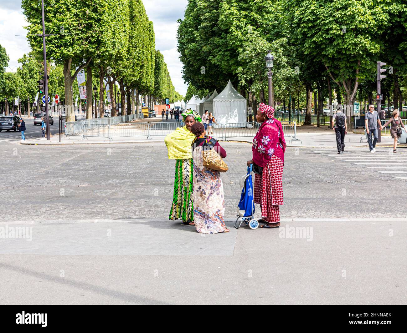 colored people in local dress have a chat at the sidewalk in the heart ...