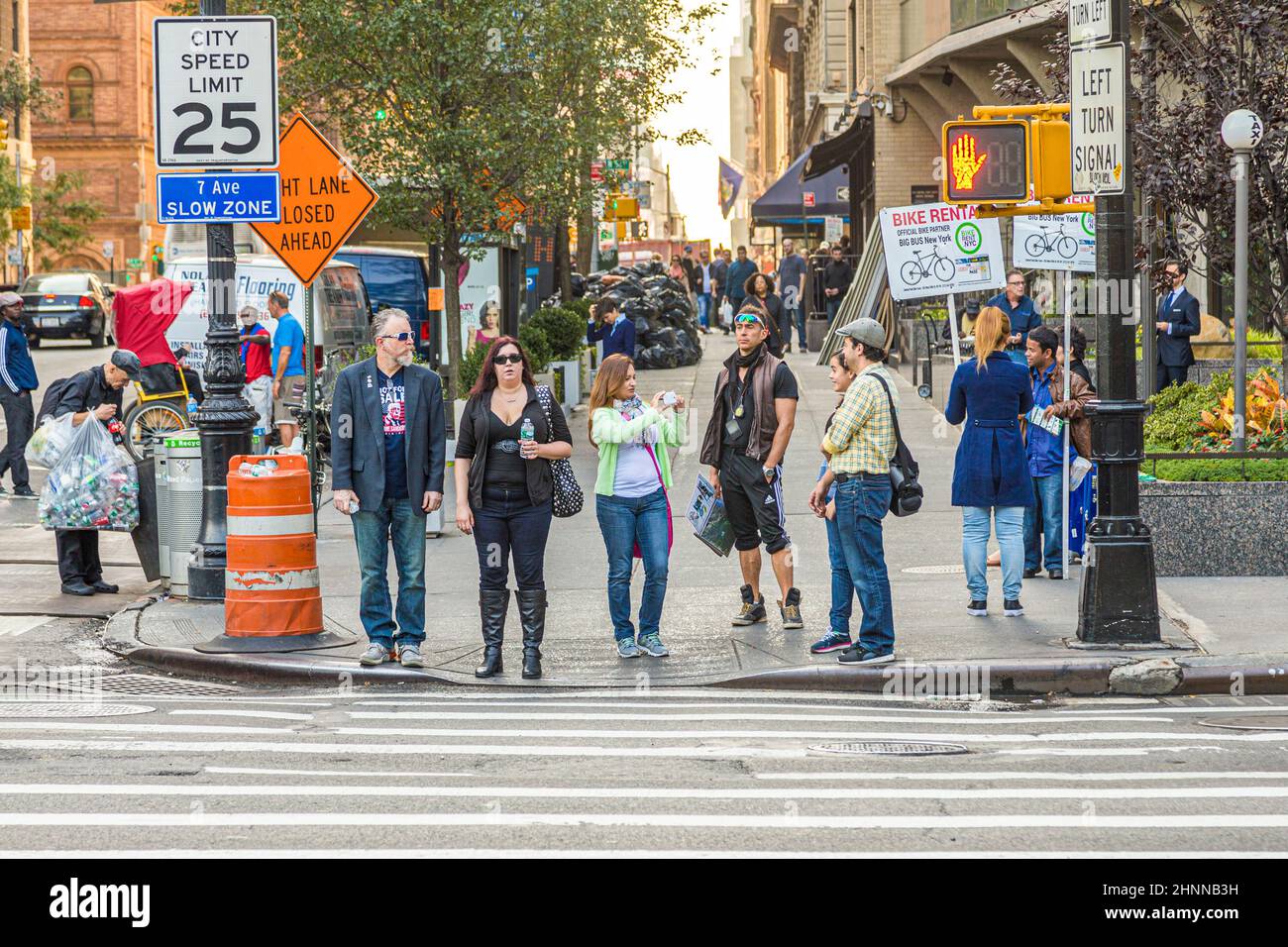 people in New York wait for green traffic light to cross the street ...