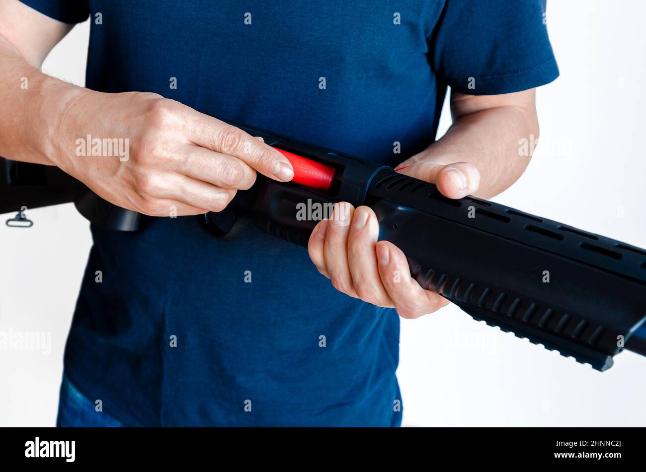 The man charges the shotgun with ammunition. Charging a pump smoothbore ...