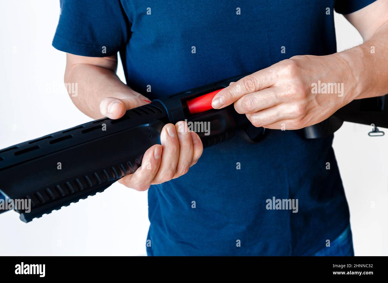 The man charges the shotgun with ammunition. Charging a pump smoothbore ...
