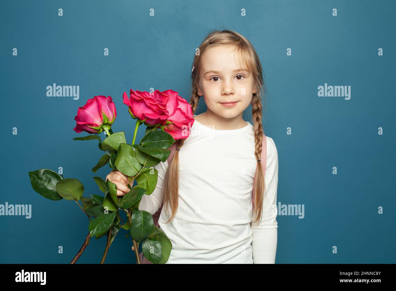 Happy cute child girl holding rose flowers as present for mother or ...