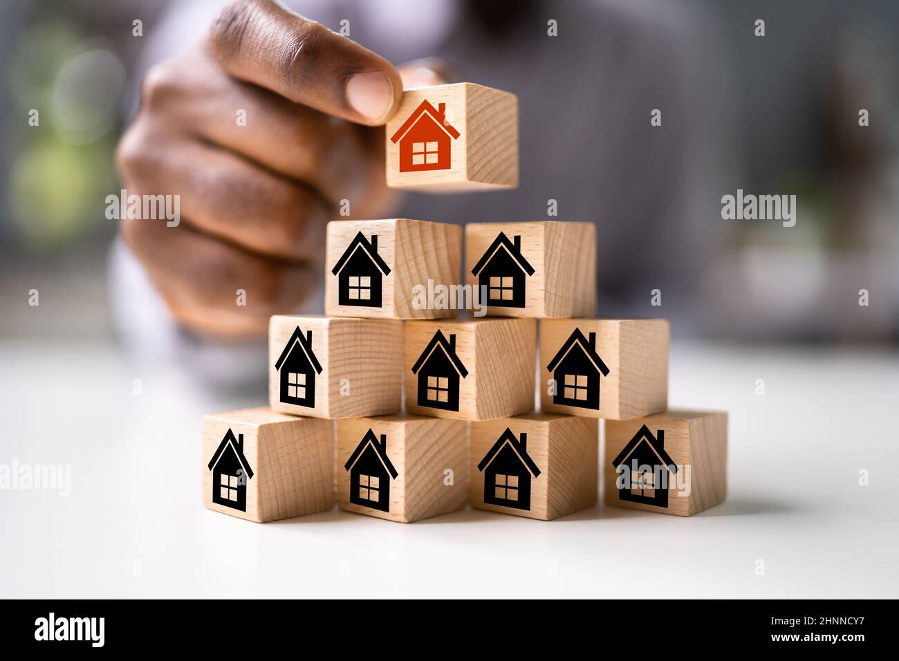 Real Estate House Community. African Man Stacking Housing Blocks Stock ...