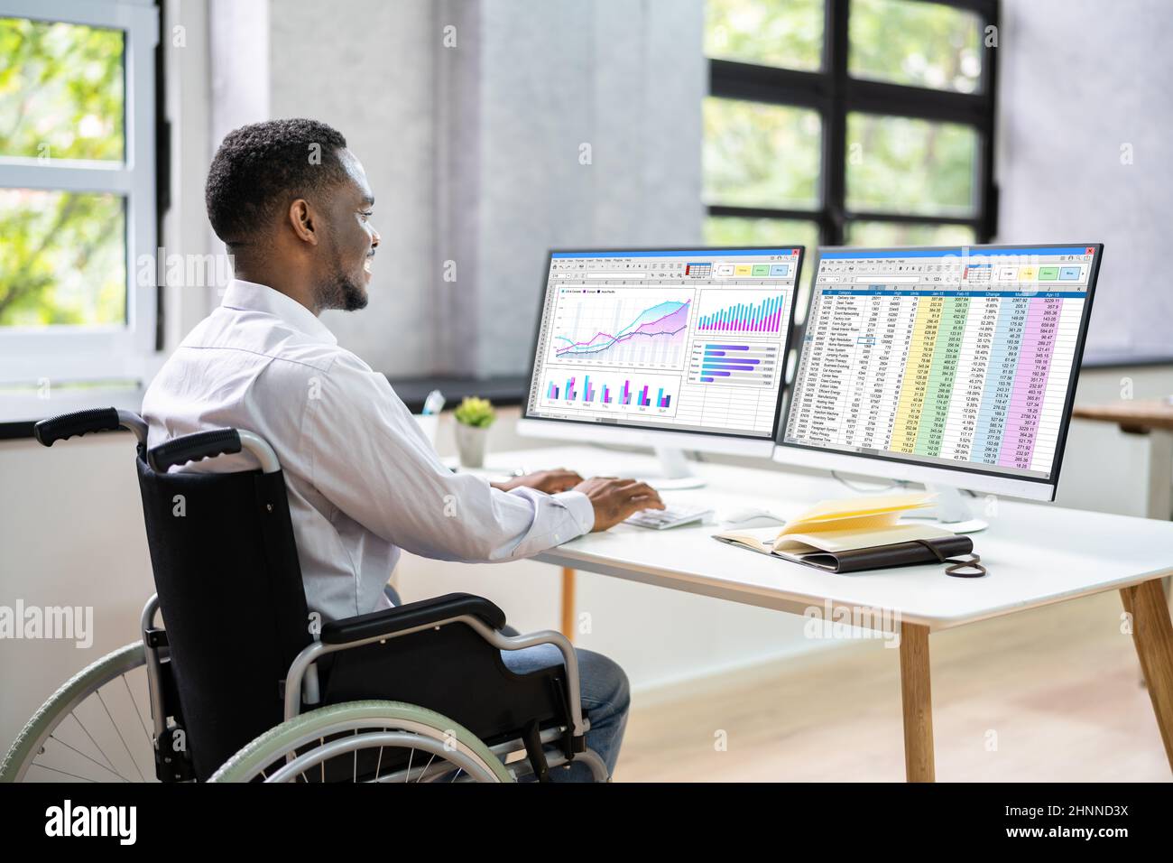 Medical Coding Spreadsheet On PC. African Man In Wheelchair Stock Photo ...