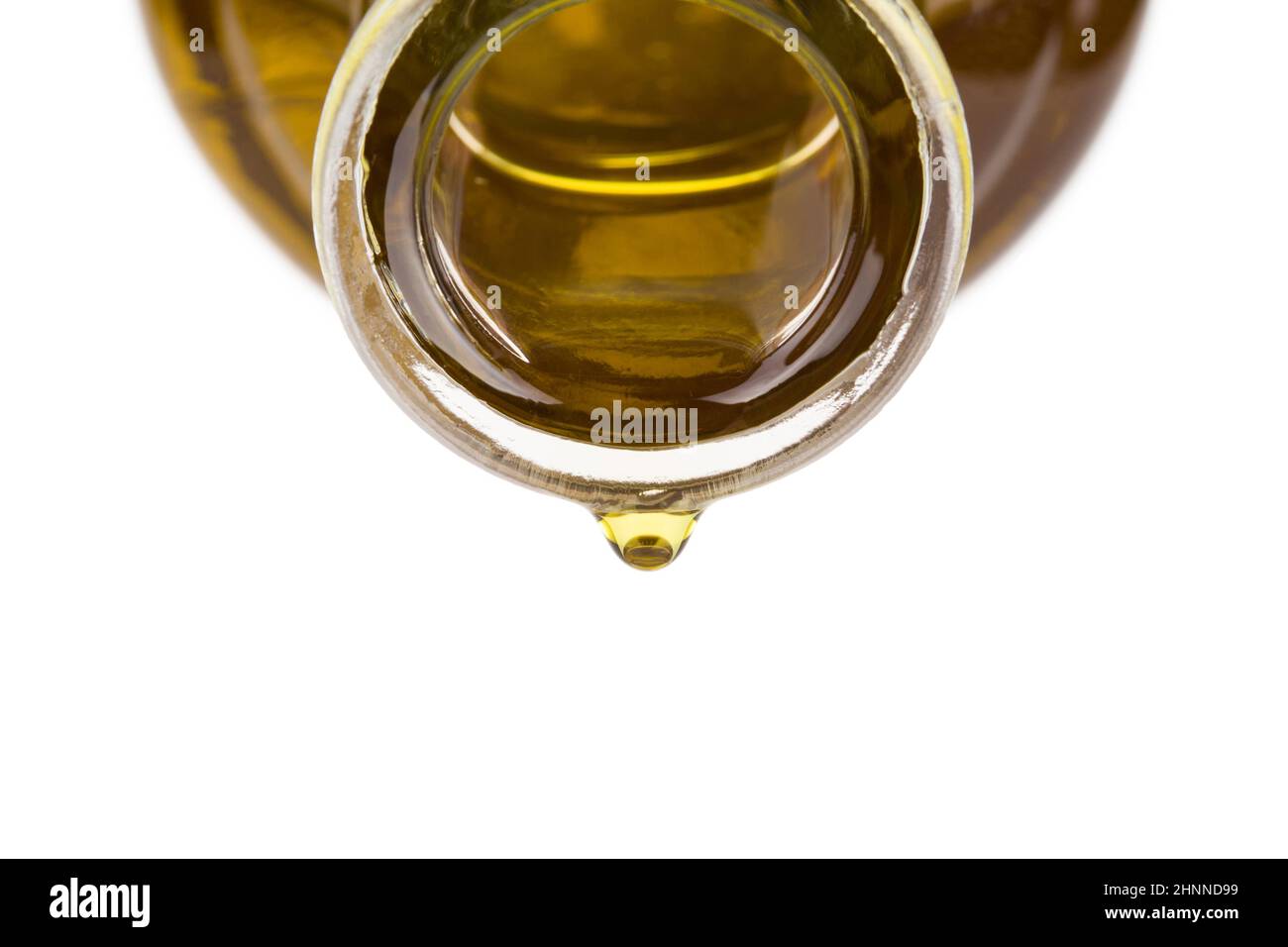 Oil drop on a bottle. Oil pouring from a bottle Stock Photo - Alamy