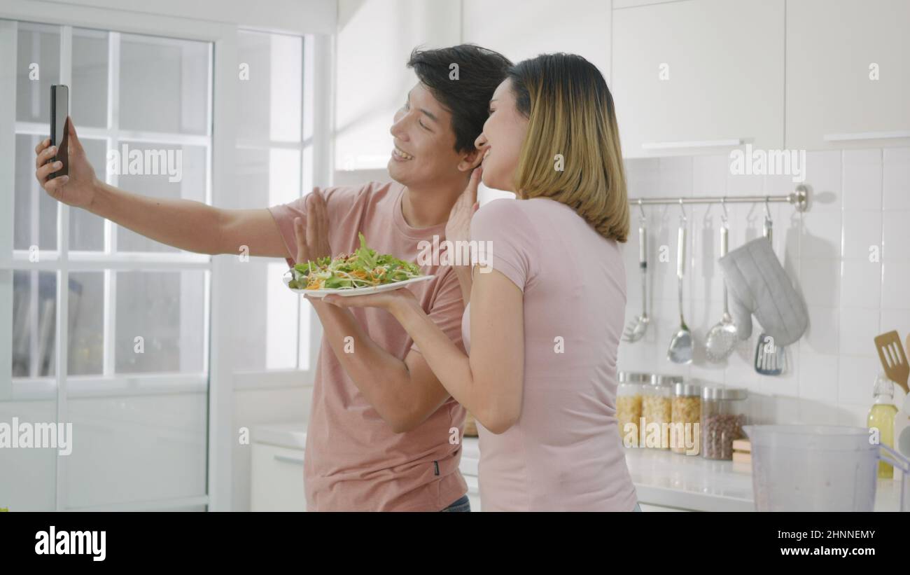 Happy Asian beautiful young family couple husband and wife enjoying ...