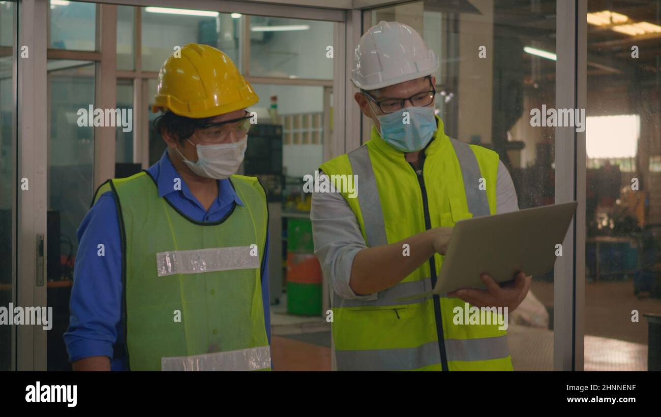 Two factory industrial workers technician or engineer worker and ...