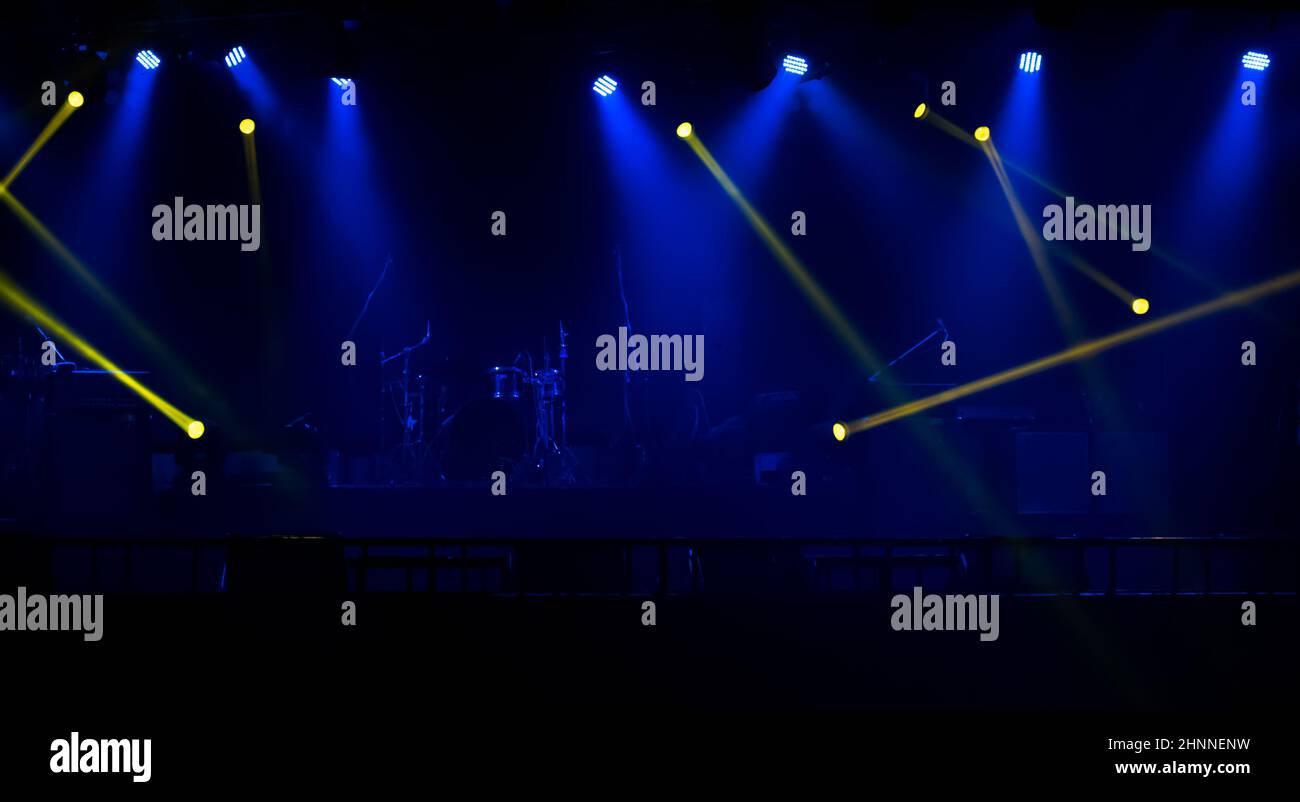 Blue and yellow stage spotlights with smoke. Floodlights of concert ...