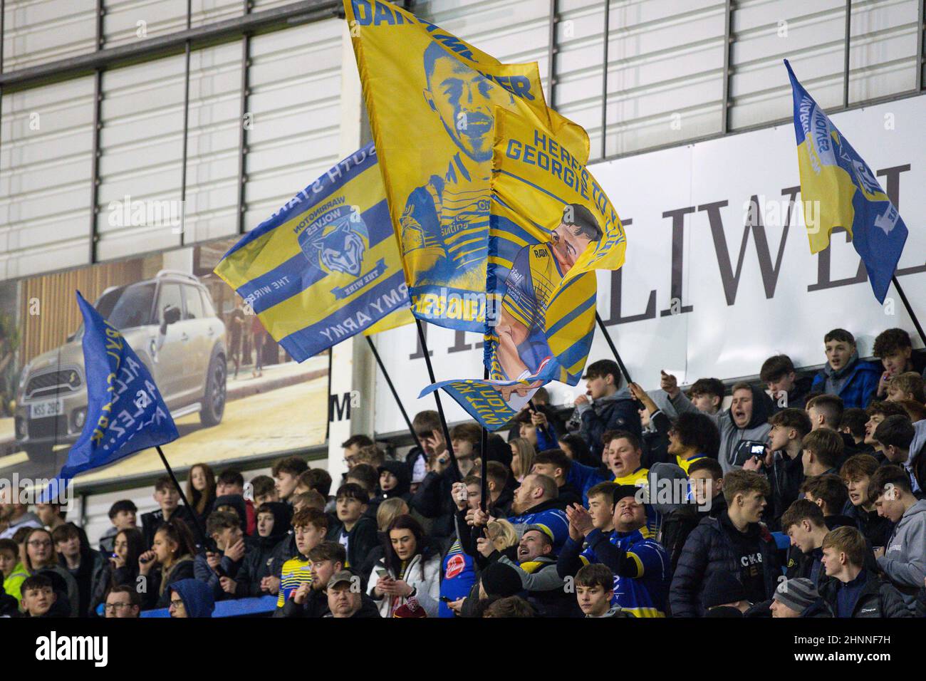 Warrington Wolves fans waving fans as the teams warm up Stock Photo - Alamy