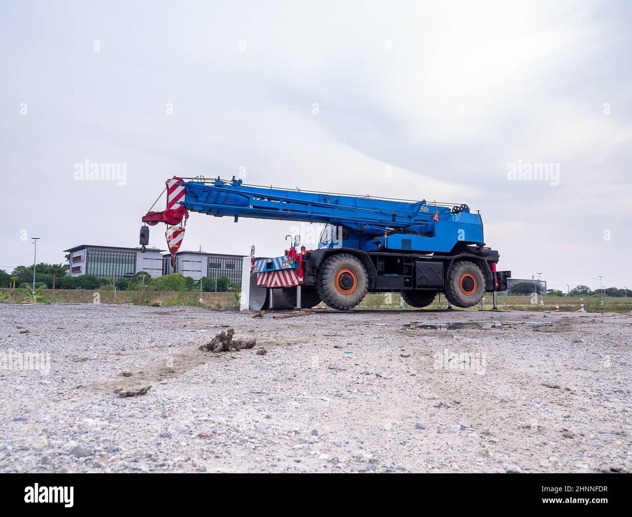 Construction site crane is lifting a led signboard for advertisement ...