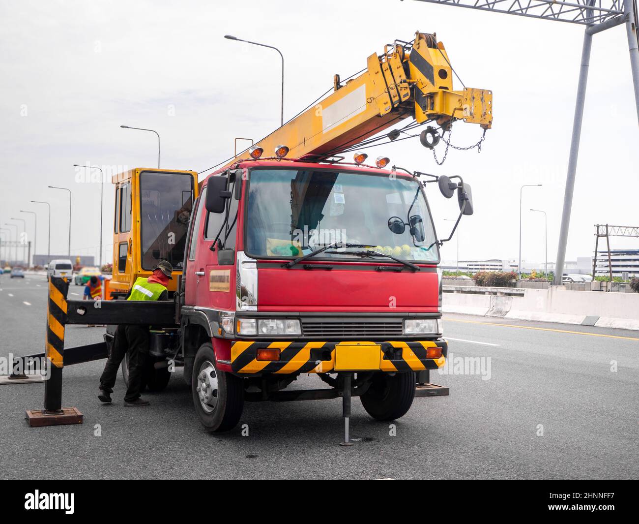 Construction site crane is lifting a led signboard for advertisement ...