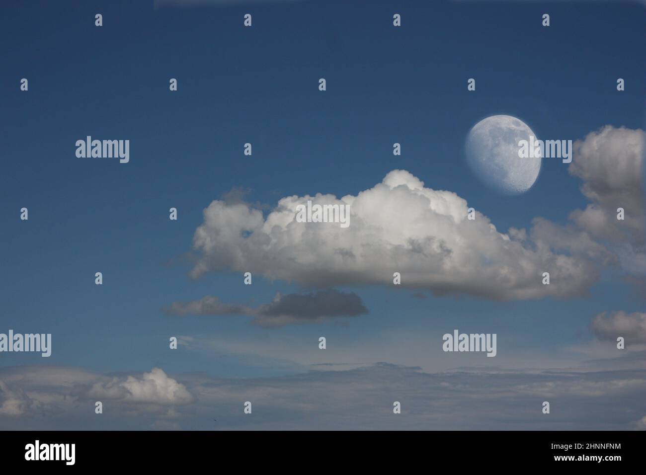 Blue cloudy sky with moon Stock Photo - Alamy