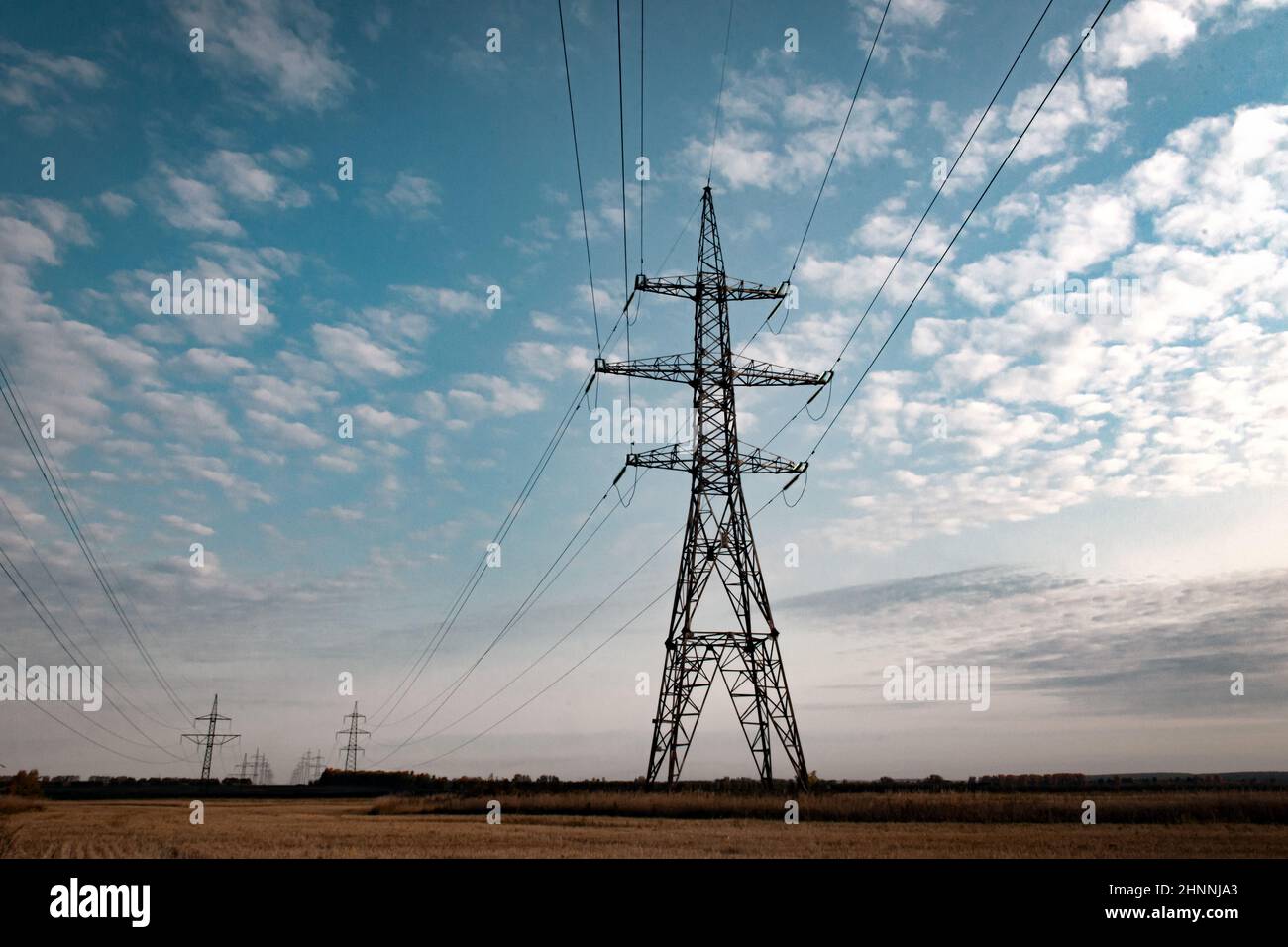 power lines on the evening sky background Stock Photo - Alamy