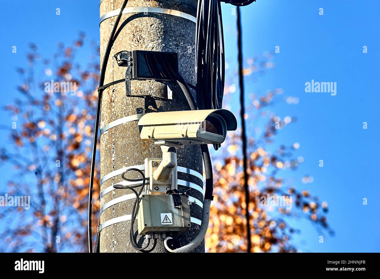 a surveillance camera is hanging on a concrete pillar with an infrared ...