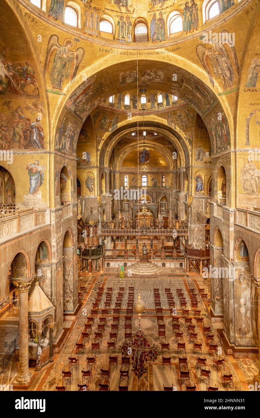 Golden wall mosaic inside St Mark`s Basilica or San Marco in Venice. It ...