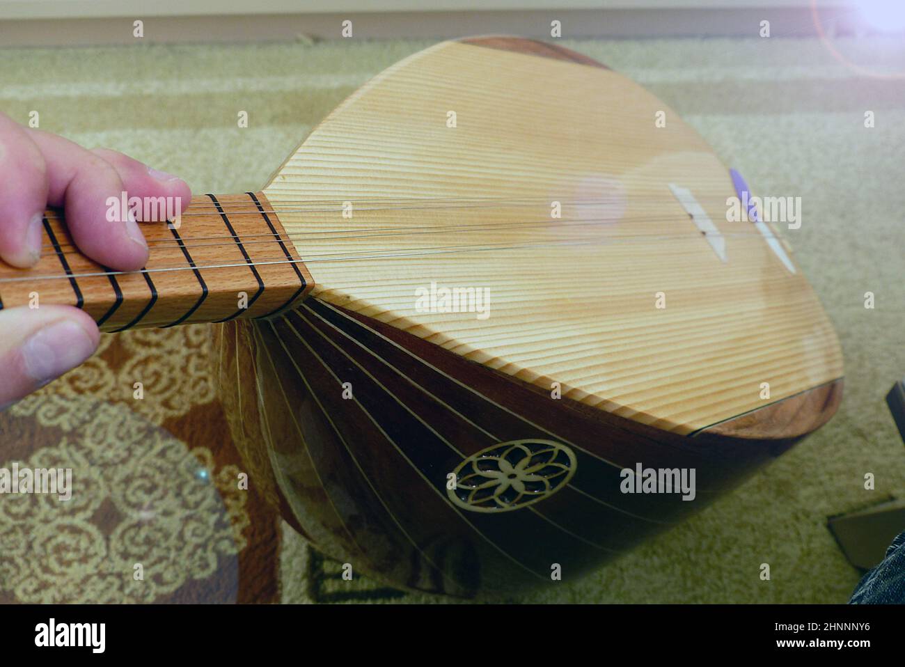 a musician is holding a saz, turkish musical instruments, close-up ...