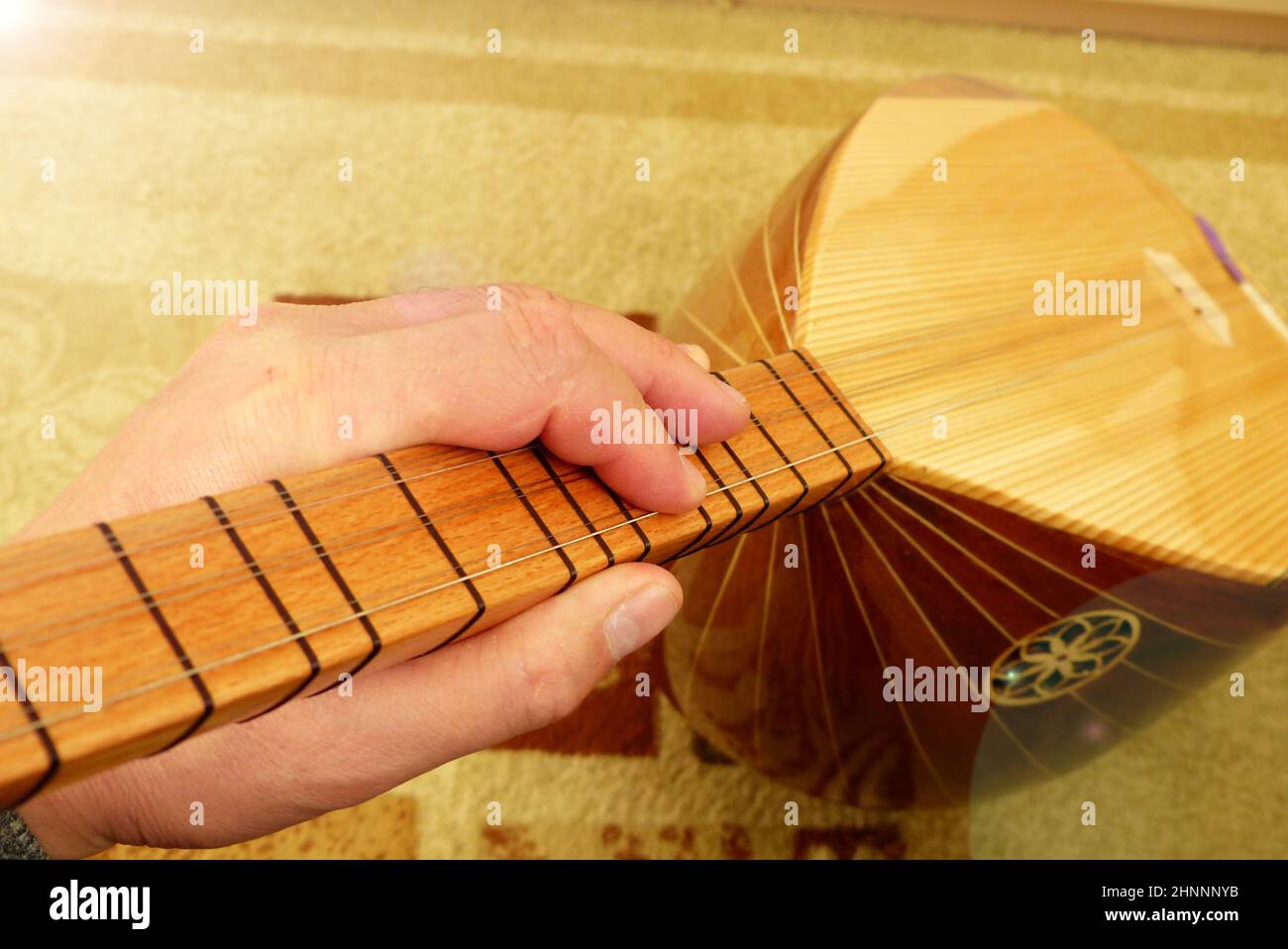 a musician is holding a saz, turkish musical instruments, close-up ...
