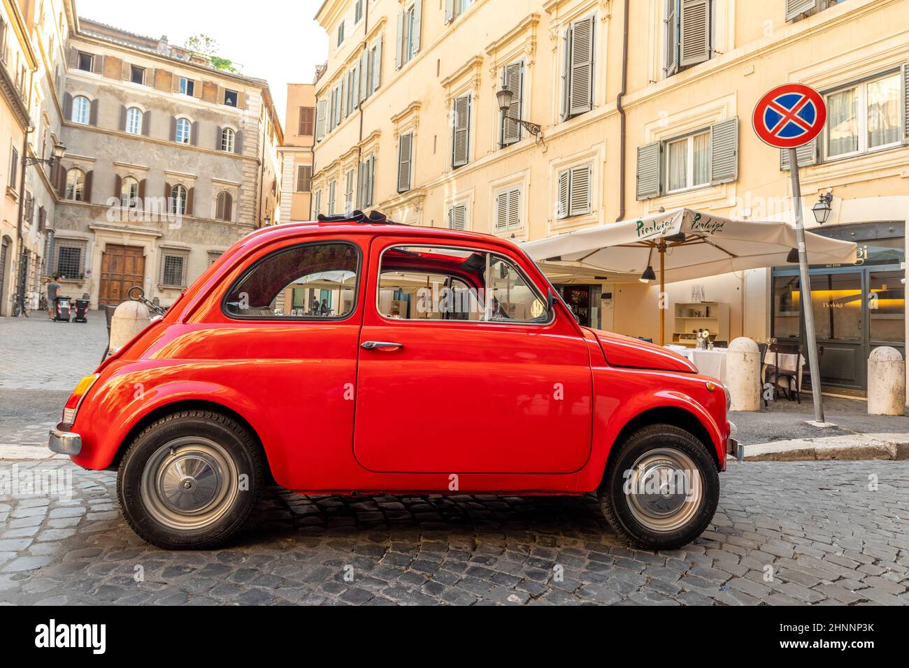 vintage Fiat 500 parked next to a restaurant in Rome in the inner city ...