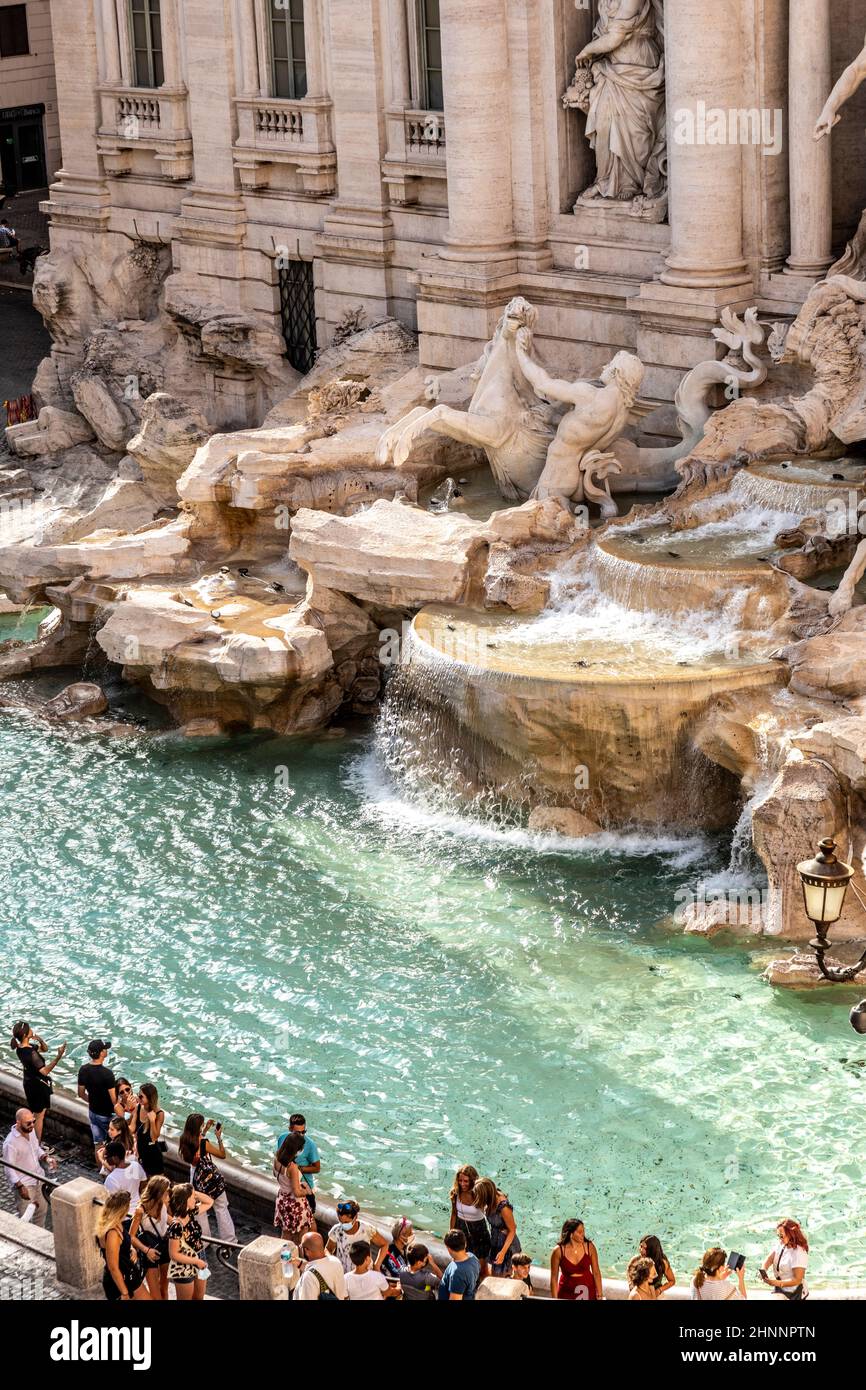 people visit the Trevi fountain in Rome. Throwing coins in the fountain ...