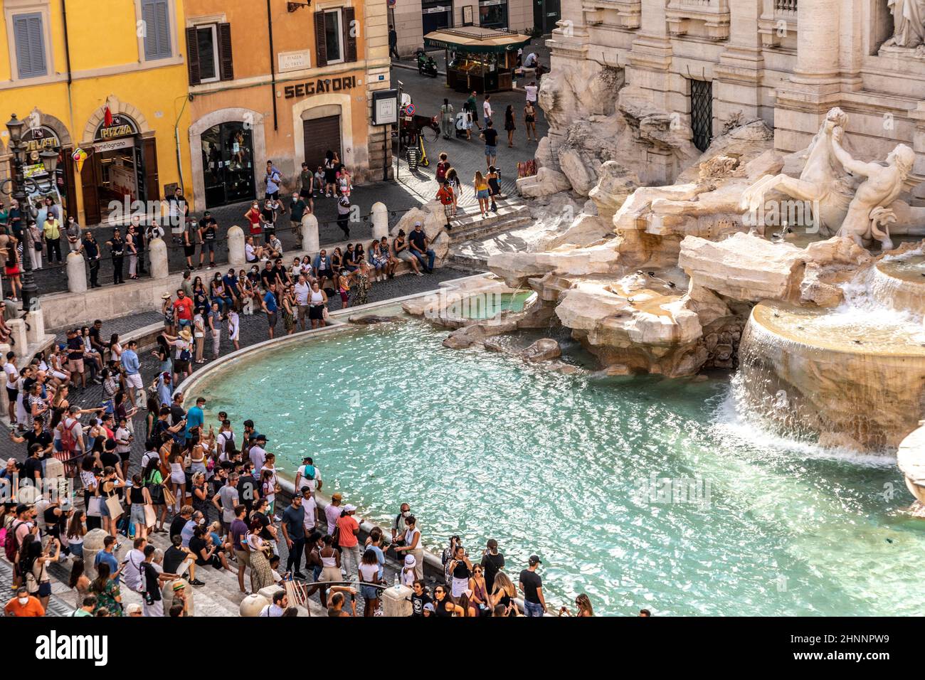 people visit the Trevi fountain in Rome. Throwing coins in the fountain ...