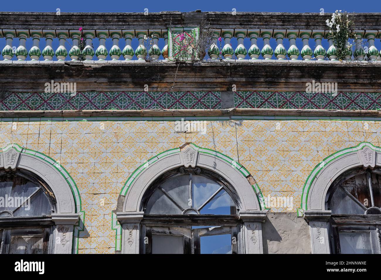 Yellow and white tile facade-old Neoclassical townhouse-three balconies ...