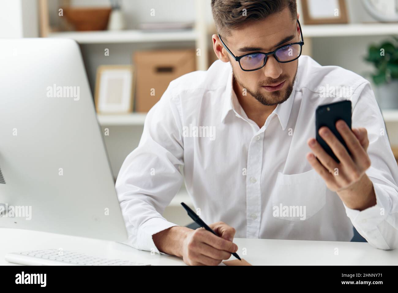 businessmen wearing glasses sits at a desk office worked technologies Stock Photo - Alamy