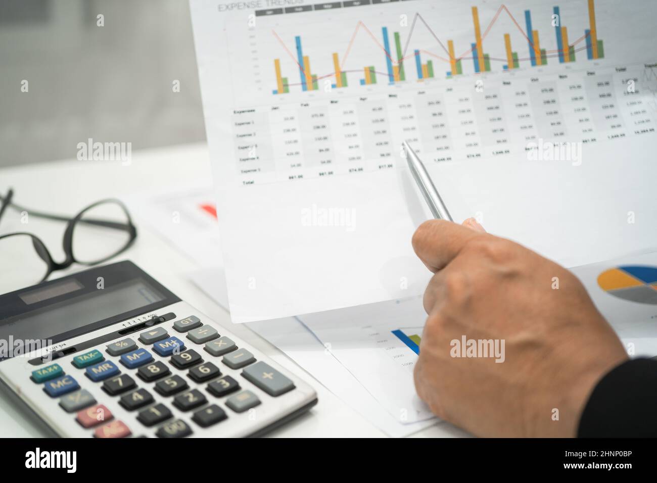 Asian accountant working and analyzing financial reports project ...