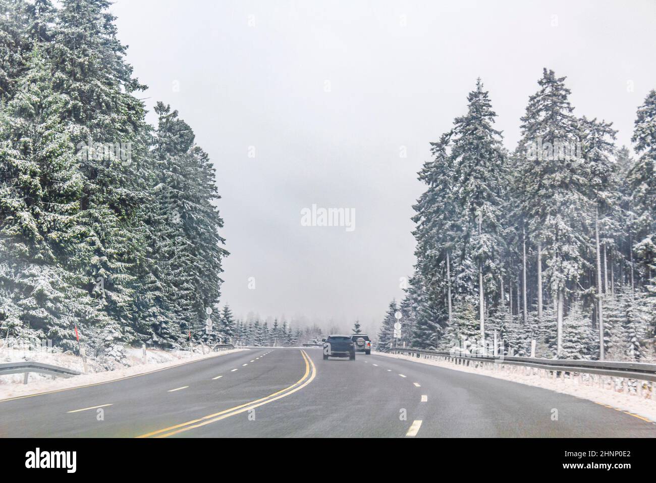 Snowy road between mountains hi-res stock photography and images - Alamy