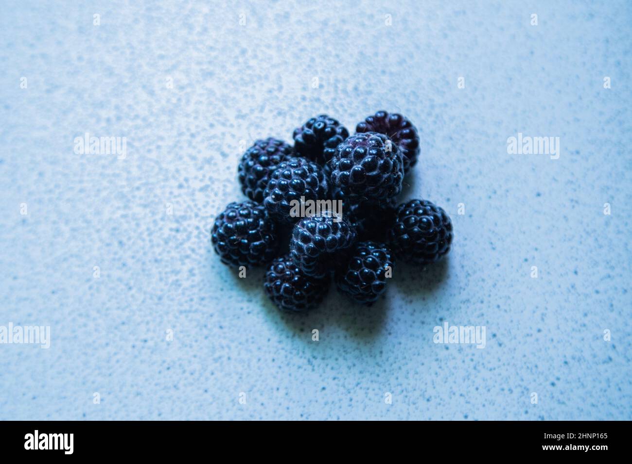 BlackBerry berries stacked in a pyramid on a light background. High ...