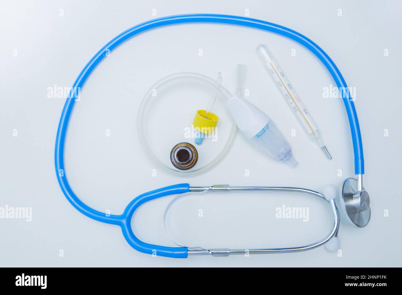 The stethoscope lies on a white background around, inside it is a baby ...